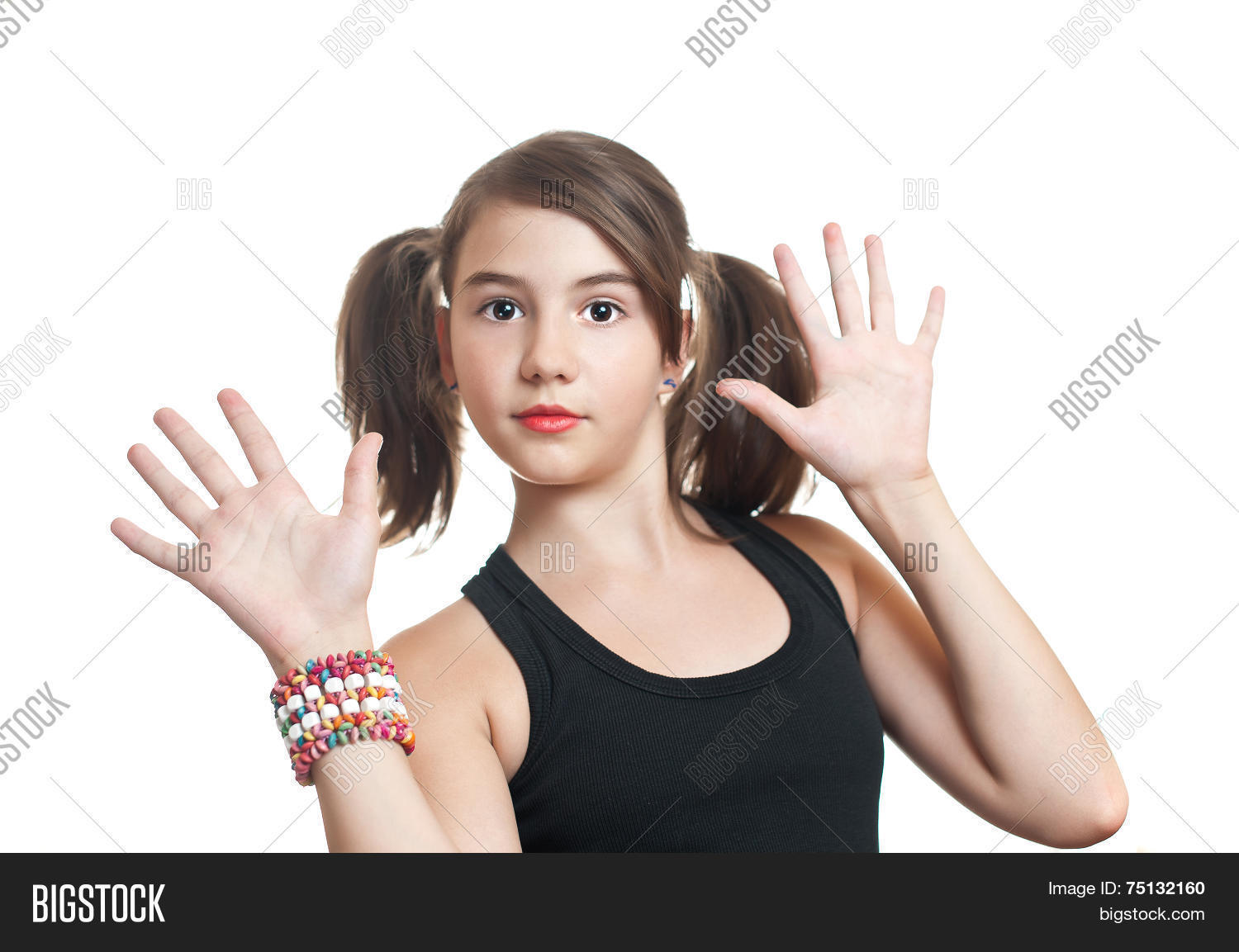 A beautiful teen girl in black top with pigtails. Portrait of smiling ...