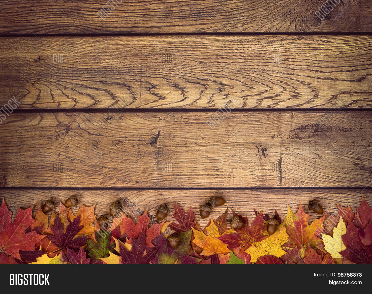 Autumn Leaves And Acorns On Rustic Wooden Background Stock Photo ...