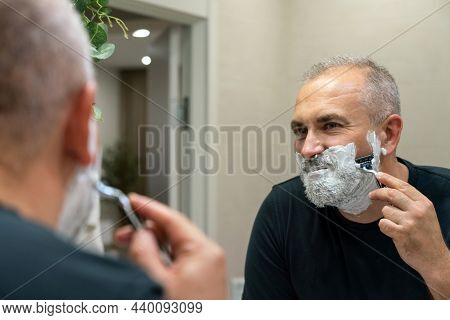 Handsome White-haired Beared Man Shaving Off His Beard Looking In A ...