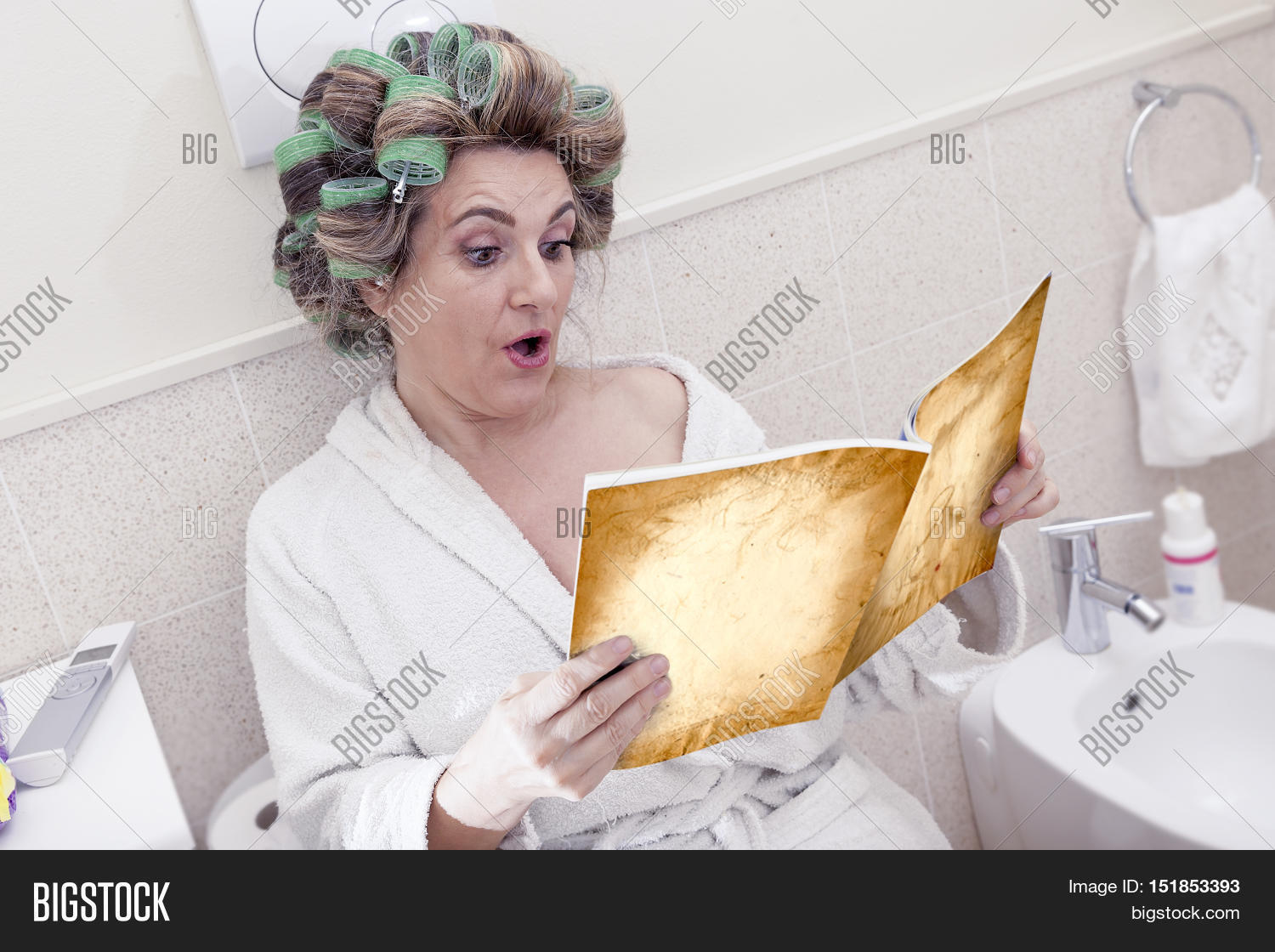 Portrait Of A Young Woman Sitting On A Toilet With Her