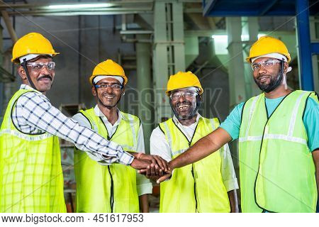 Factory Workes Witj Safety Hard Hat Joining Hands At Workplace ...