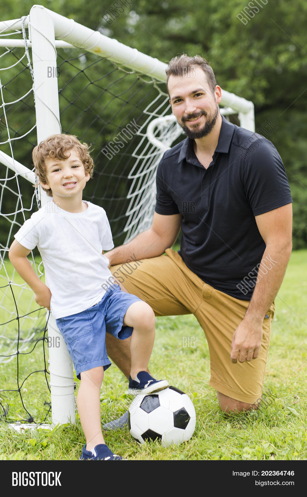 Father And Son Playing Football