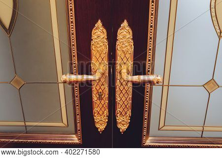Door Handles With An Old Double Door. Golden Handle Door Entrance ...