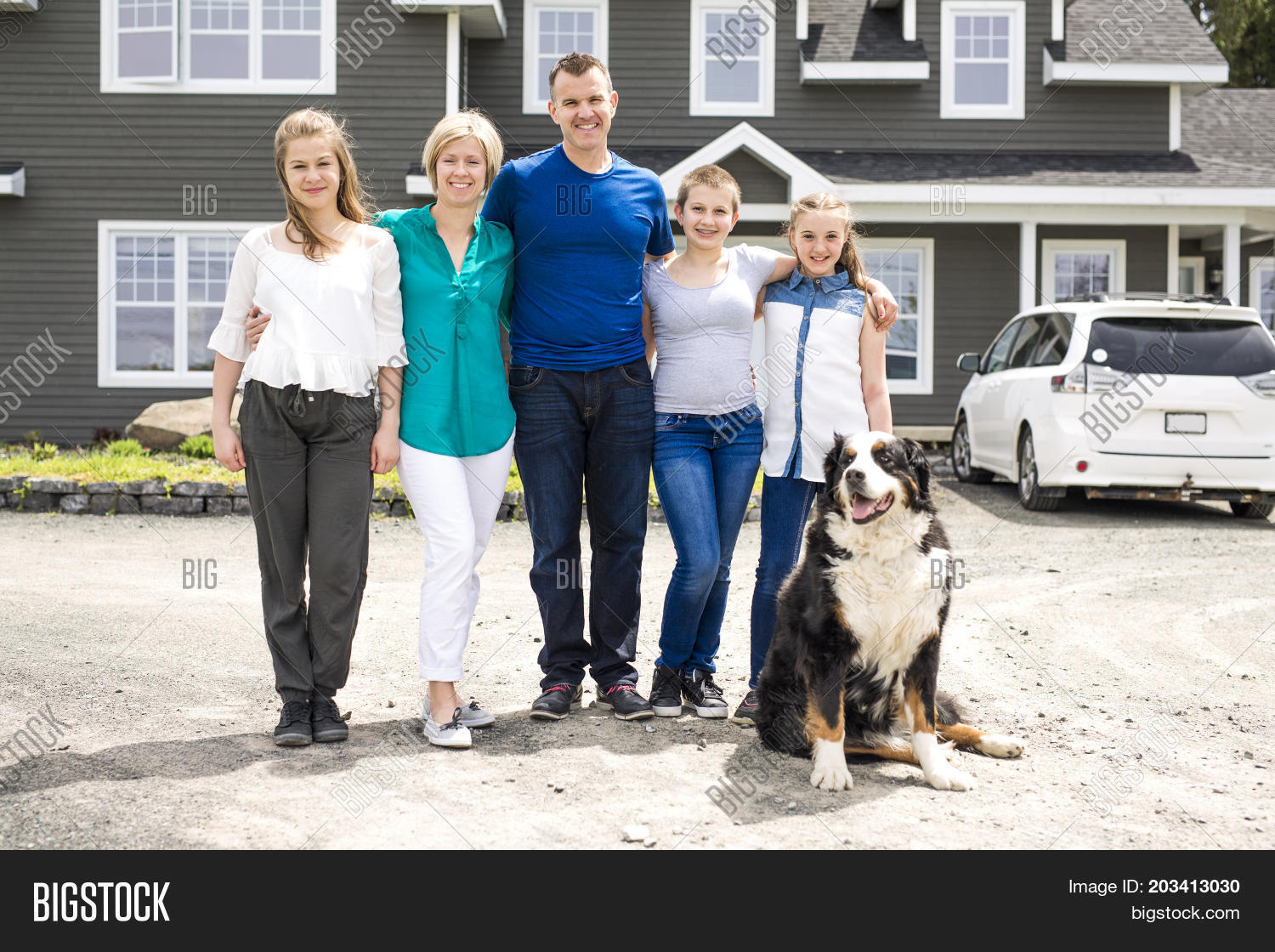 Happy Family In Front Of House
