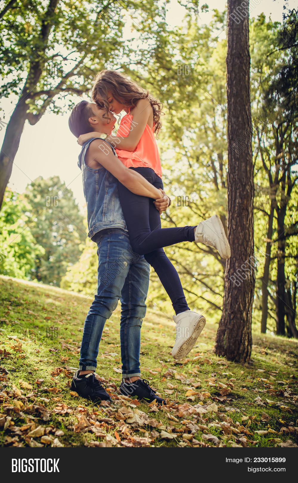 Guy Holding Girl In Arms Kissing