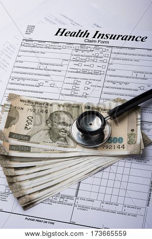 Health insurance form with indian money or currency notes of 500 and ...