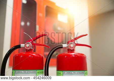 Close-up The Red Fire Extinguishers Tank At The Emergency Exit Door In ...