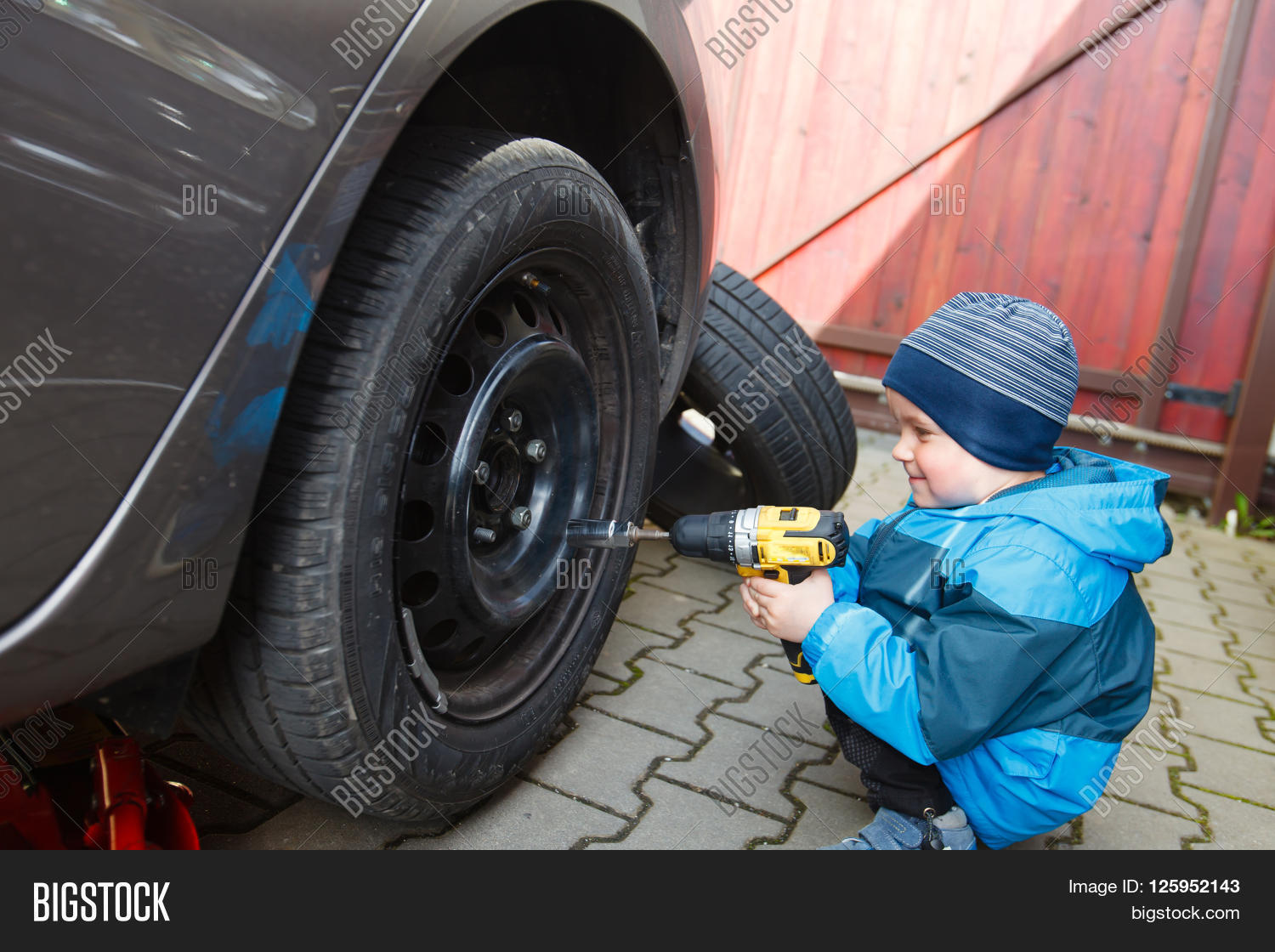 Boy Mounted Tires On Image & Photo (Free Trial) | Bigstock
