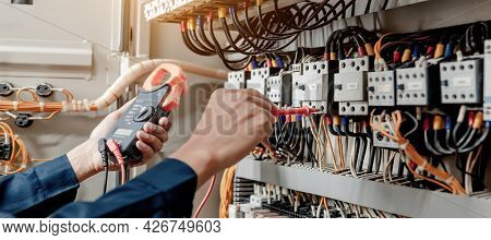 Electrician Engineer Uses A Multimeter To Test The Electrical ...