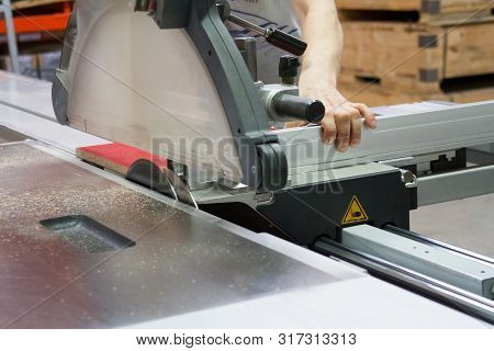 Close-up Of A Furniture Workshop Worker Sawing A Workpiece With A ...