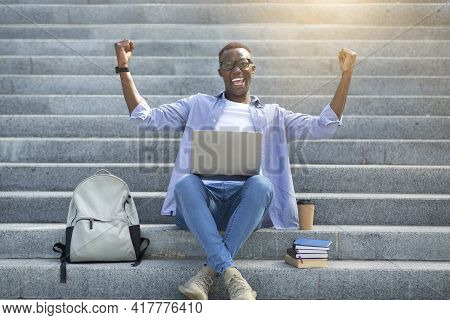 Excited African American Student Gesturing Yes In Front Of Laptop On ...