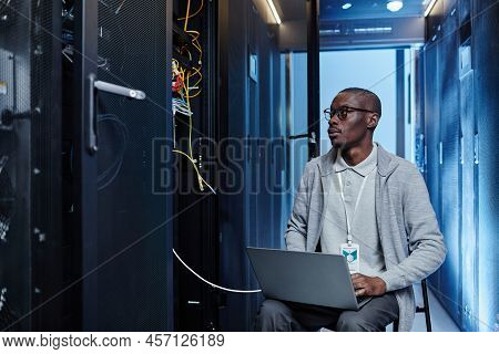 Portrait Of Black It Engineer Setting Up Server Network And Using ...