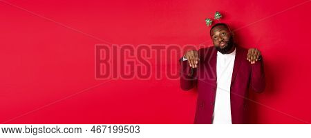 Merry Christmas. Silly And Funny Black Man In Party Headband, Imitating ...