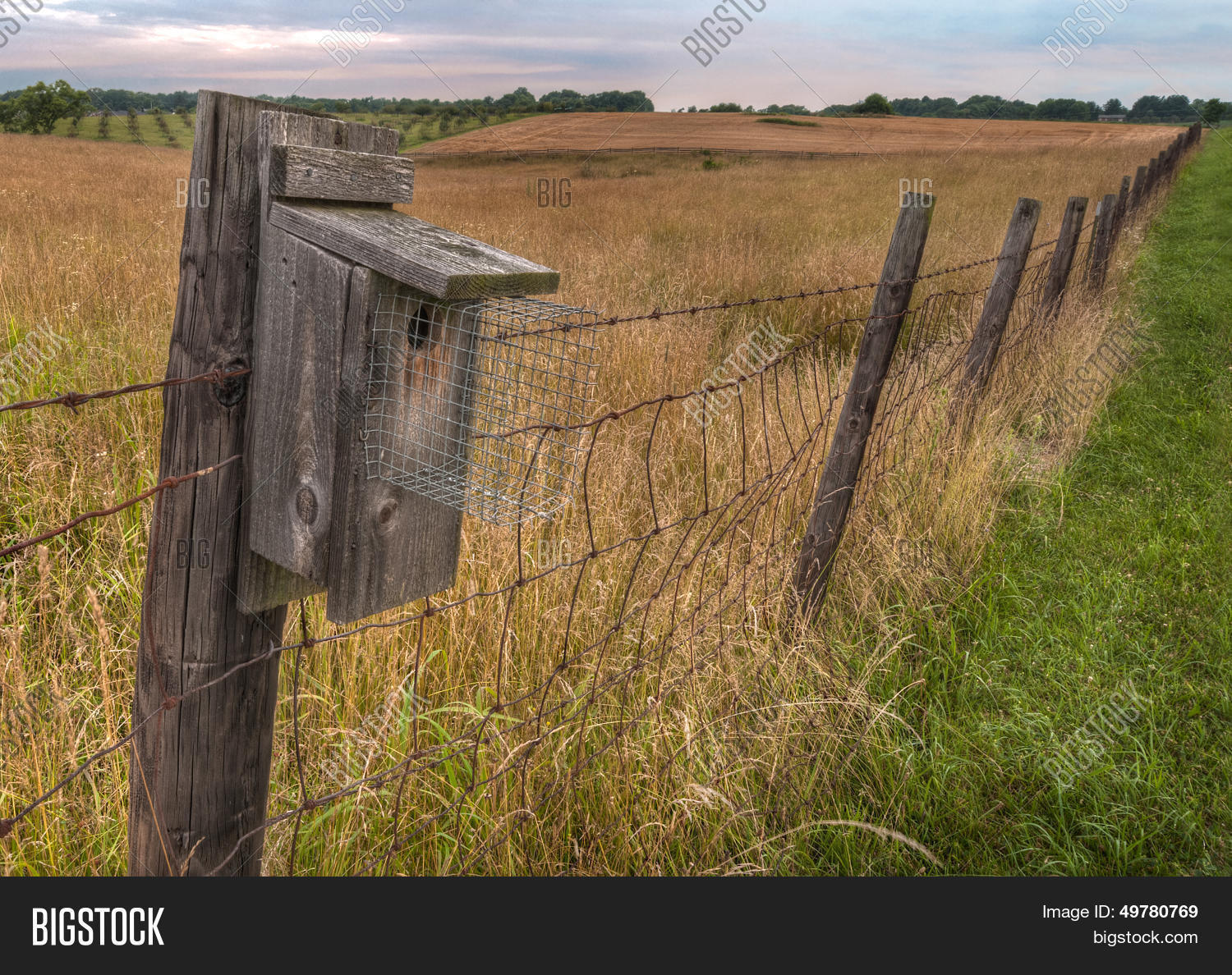 House With Barbed Wire Fence