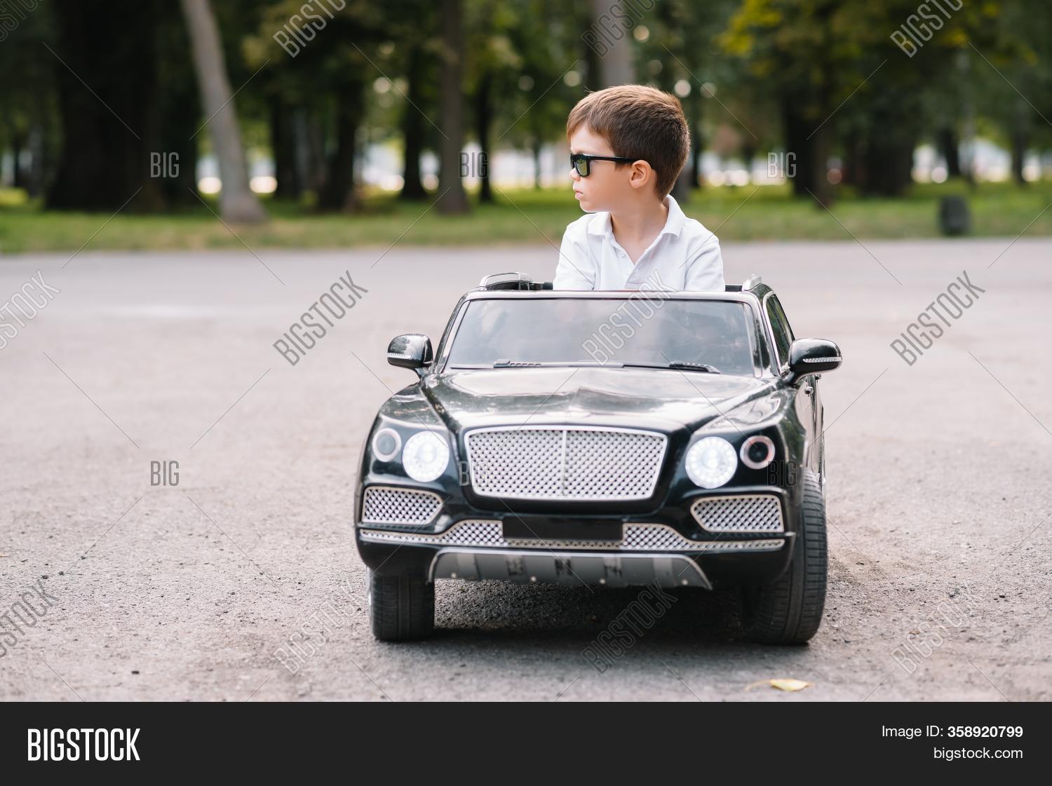 Cute Boy Riding Black Image & Photo (Free Trial) | Bigstock