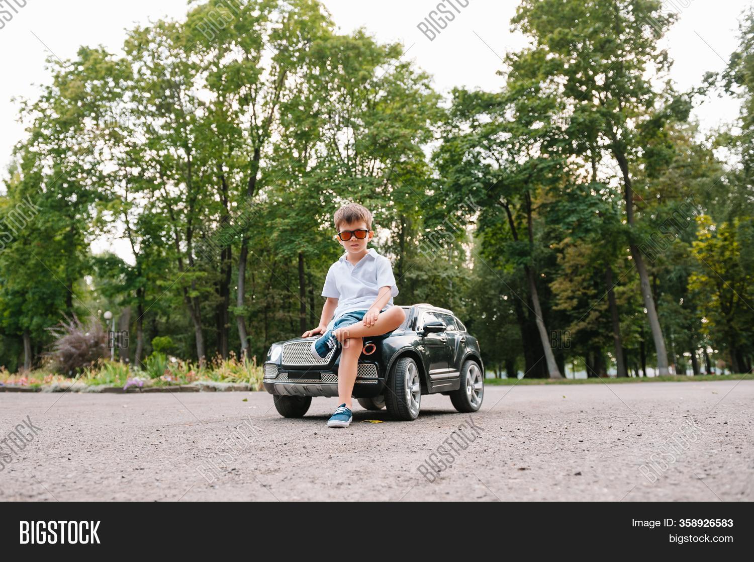 Cute Boy Riding Black Image & Photo (Free Trial) | Bigstock