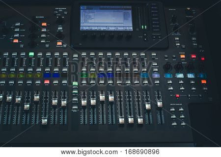 The audio equipment, control panel of digital studio mixer, front view. Close-up, selected focus ...