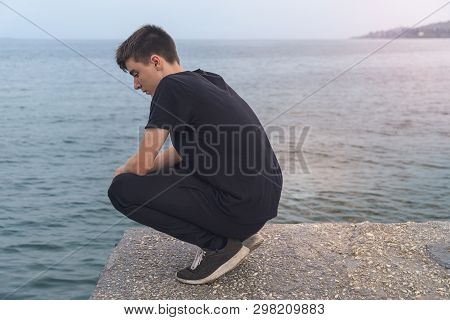Young Man Crouching On Image & Photo (Free Trial) | Bigstock