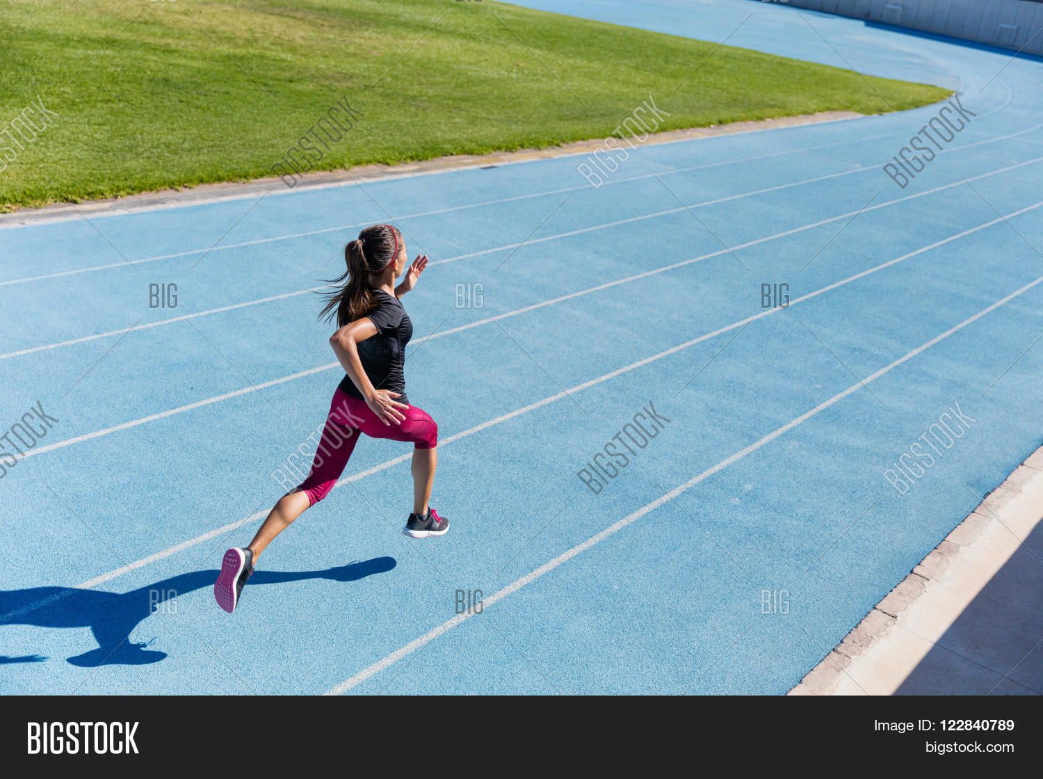 Runner sprinting towards success on run path running athletic track ...
