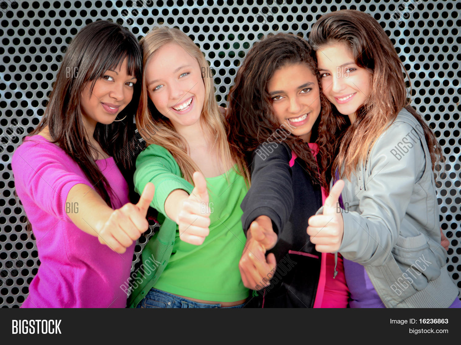 Happy diverse group of teenage girls showing thumbs up Stock Photo ...