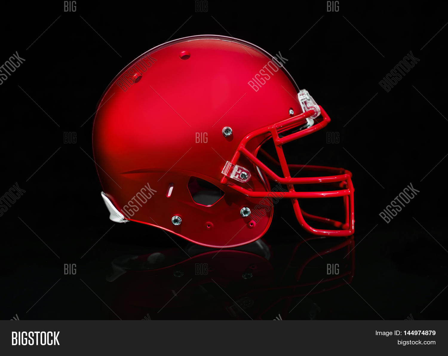 Side view of a red football helmet on a black background Stock Photo ...