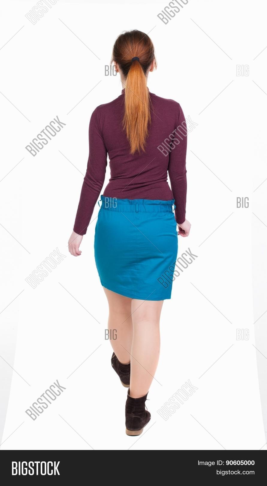 side view of walking woman in dress. beautiful girl in motion. backside ...