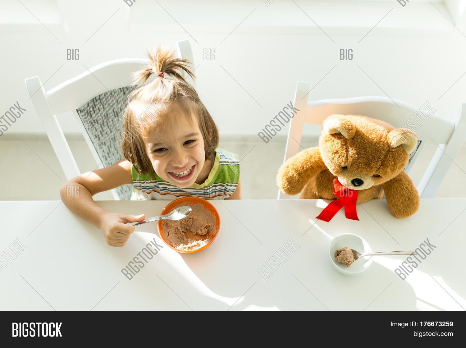 Little cute child playing with Teddy bear at home having fun and ...