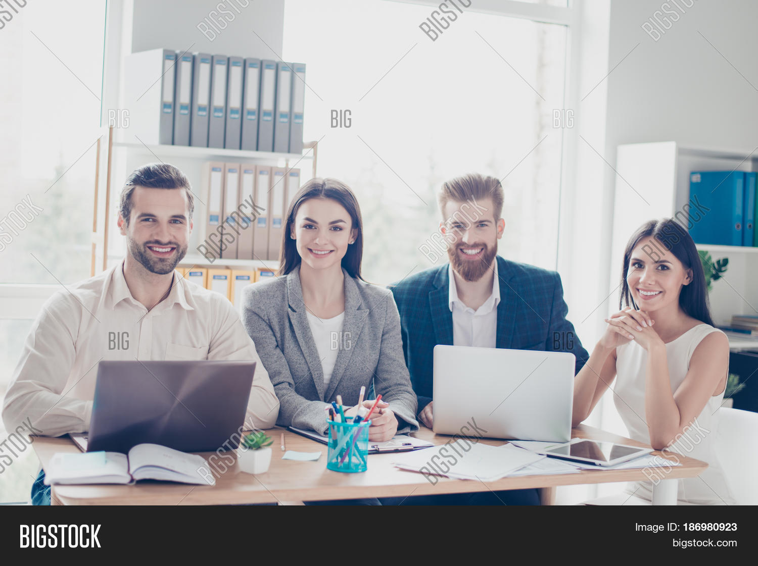 Group Of Cheerful Successful Young Business People Welcoming In Their ...