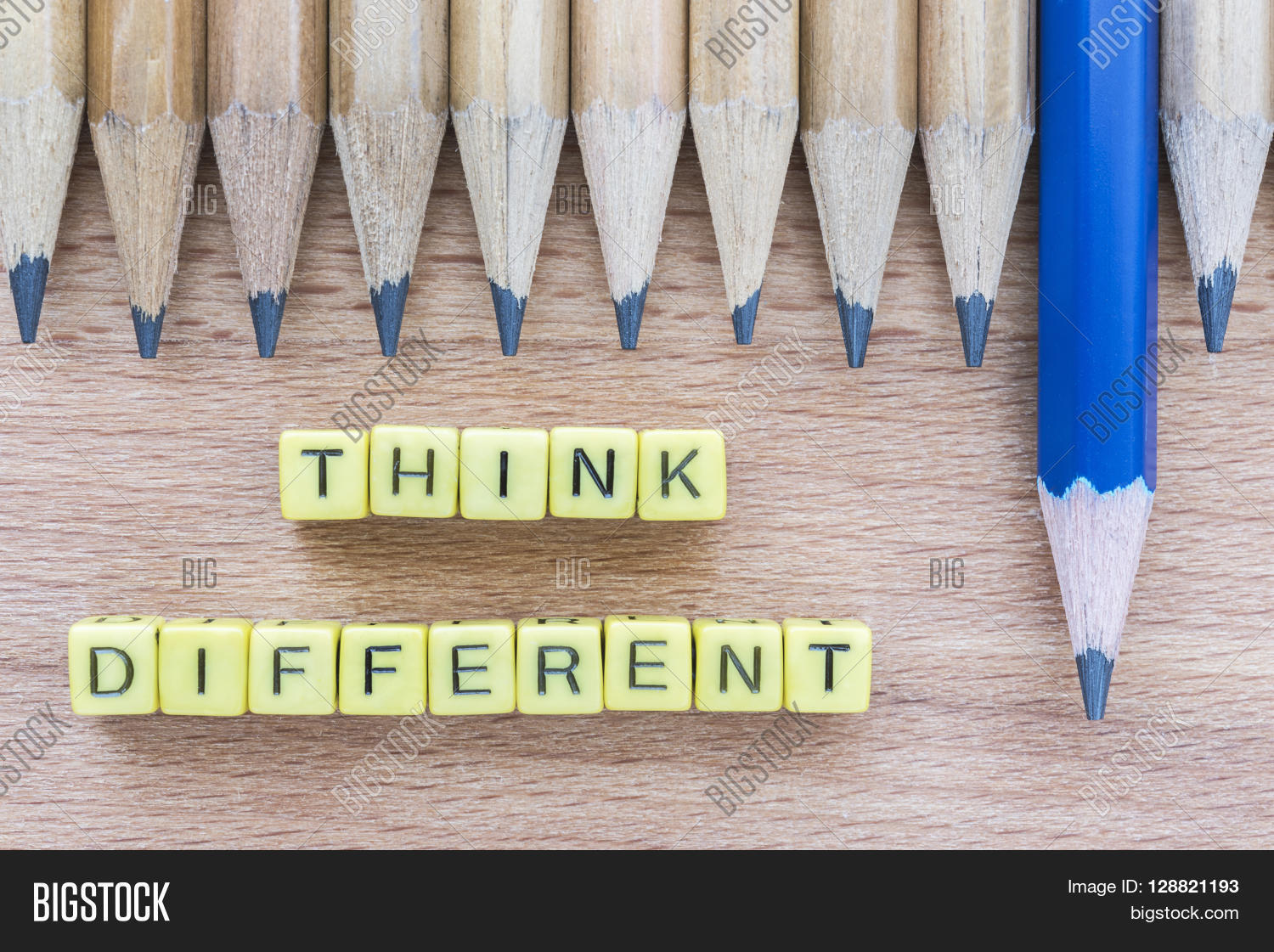 Words Think Different motivational slogan on wooden table with group of ...